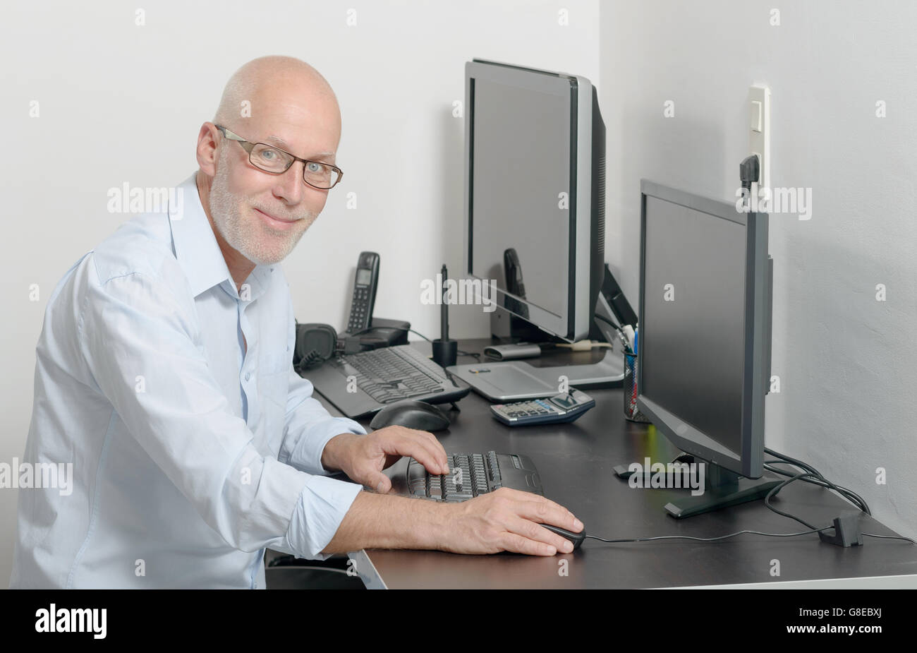 a mature man working with his computer Stock Photo - Alamy