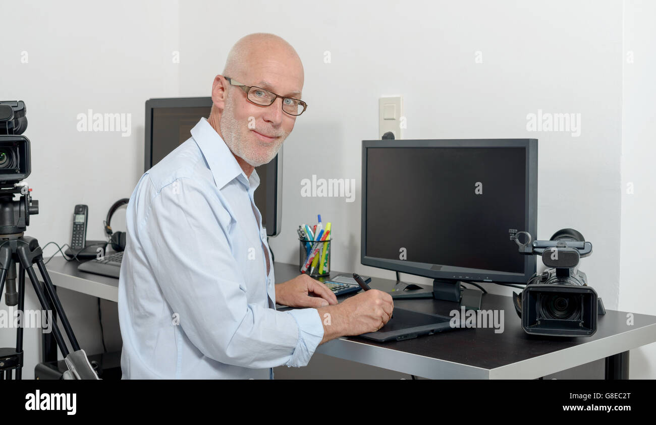 Cheerful senior executive using computer hi-res stock photography and ...