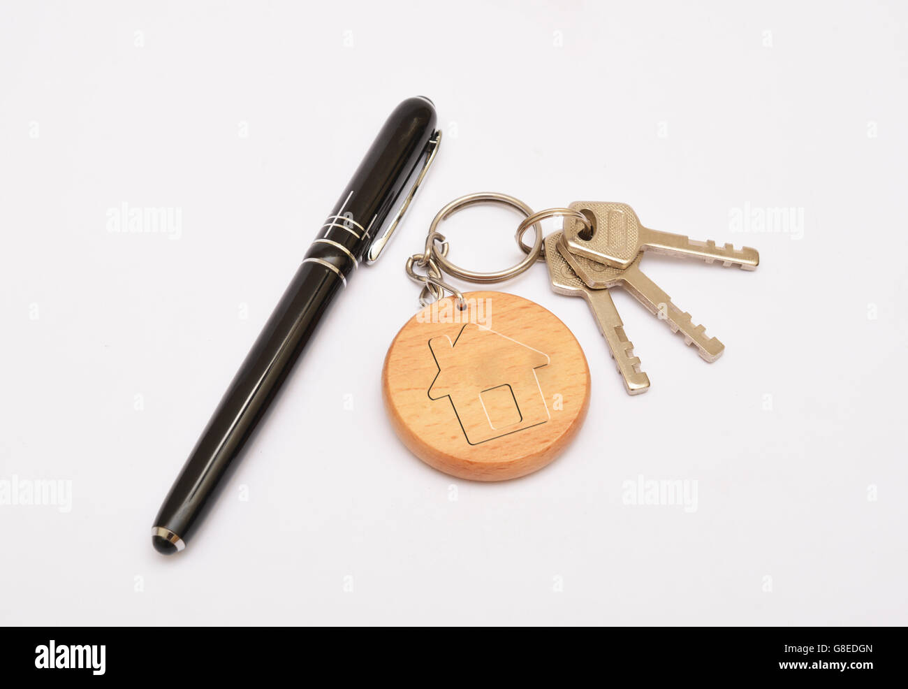 Metal door keys with pen and key ring isolated on white background ...