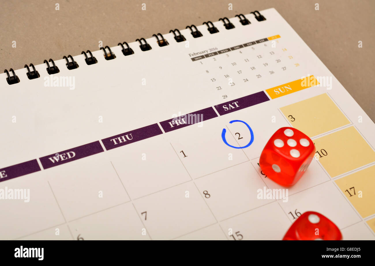 Blue Circle marked on Calendar with Red Dice Stock Photo - Alamy