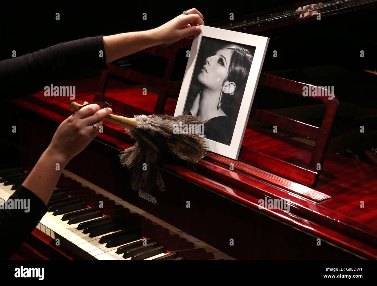 Hannah Willetts, specialist from Lyon and Turnbull, dusts a baby grand ...