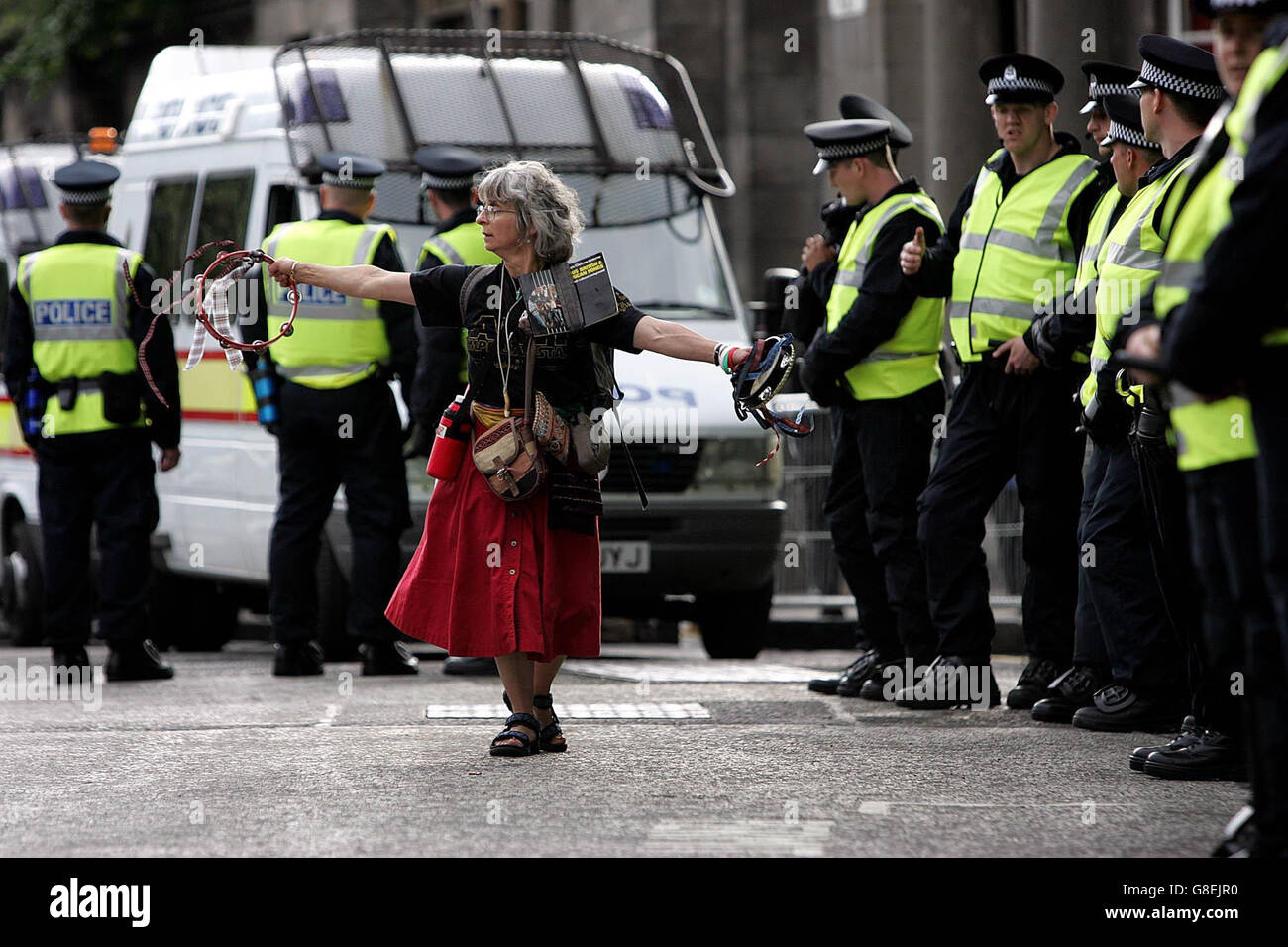 A demonstrator dances among police, Edinburgh, during a demonstration ...