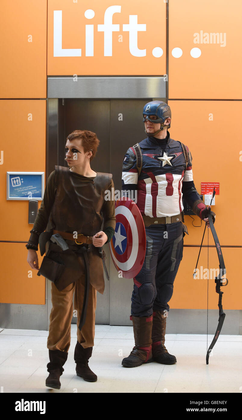 A man dressed as Captain America waits by the lift during MCM Comic Con ...