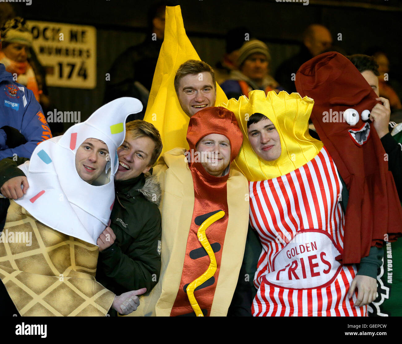 A general view of fans in the stands dressed as fast food Stock Photo ...