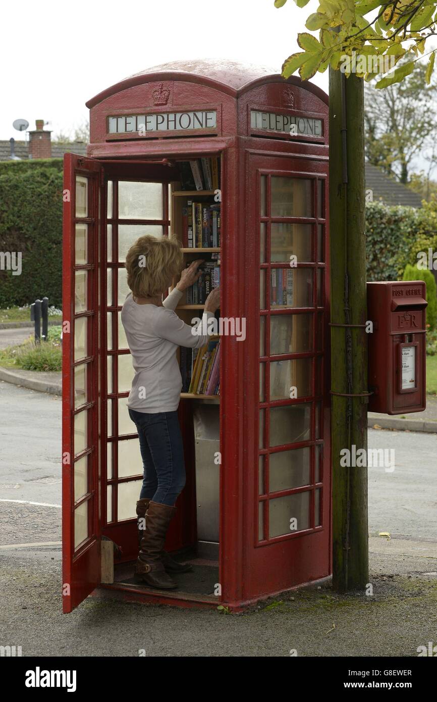 Wendy Hanlon looks at books in a red phone box which has been converted ...
