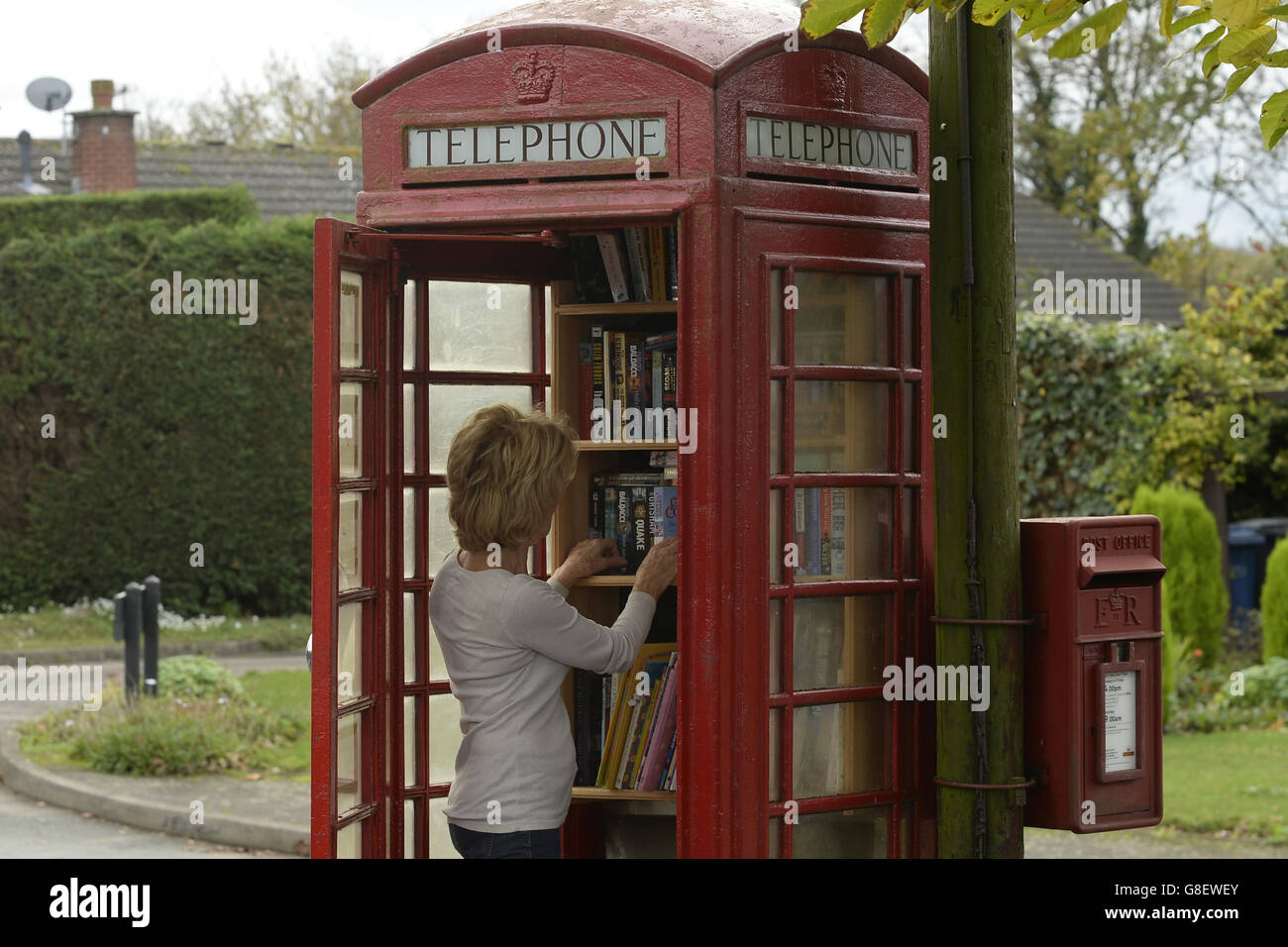 Wall village telephone box library Stock Photo - Alamy