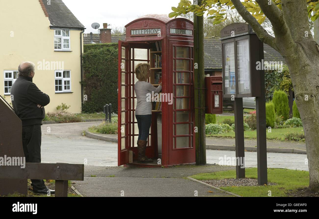 Wendy Hanlon looks at books in a red phone box which has been converted ...