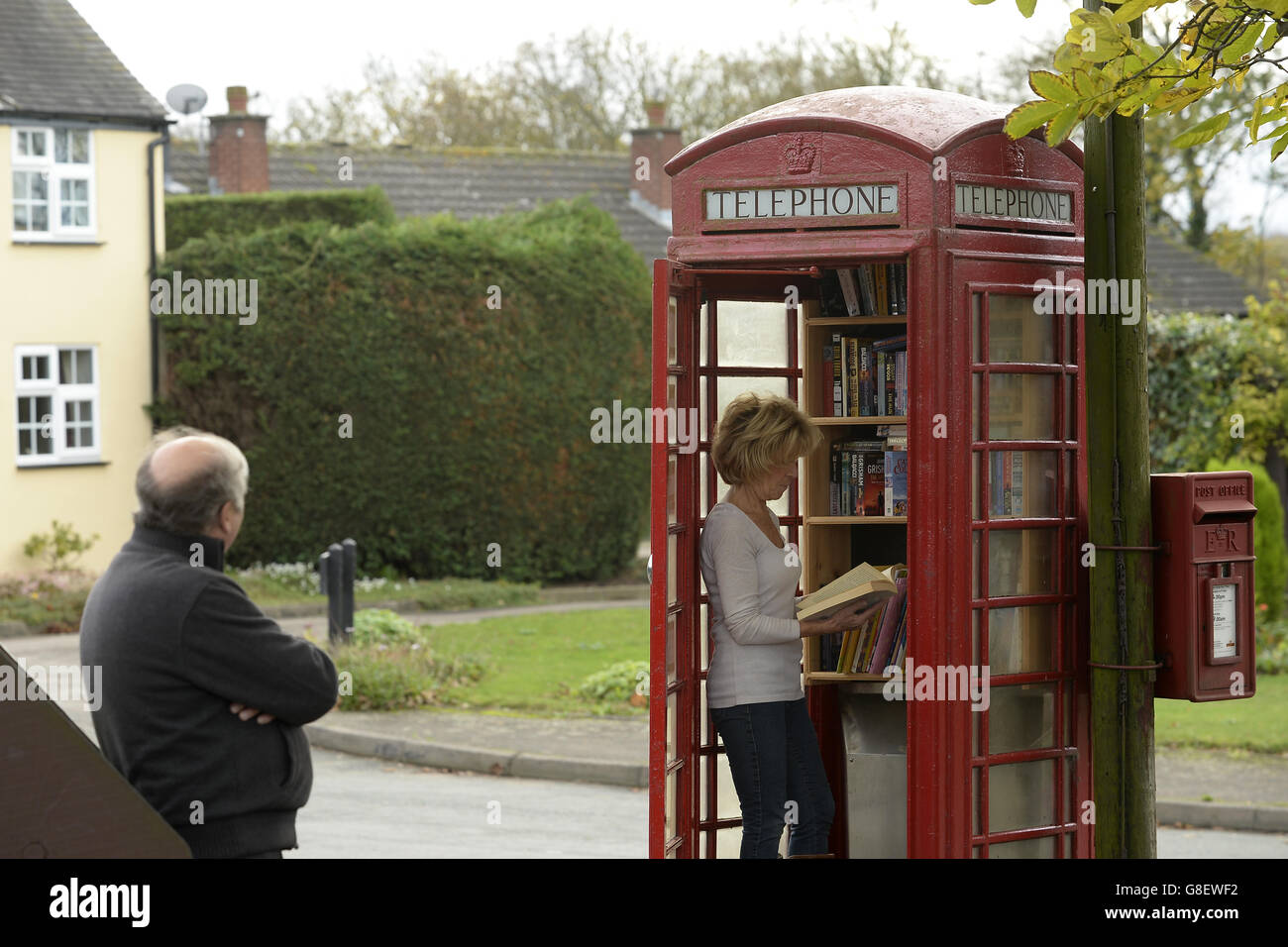 Wendy Hanlon looks at books in a red phone box which has been converted ...