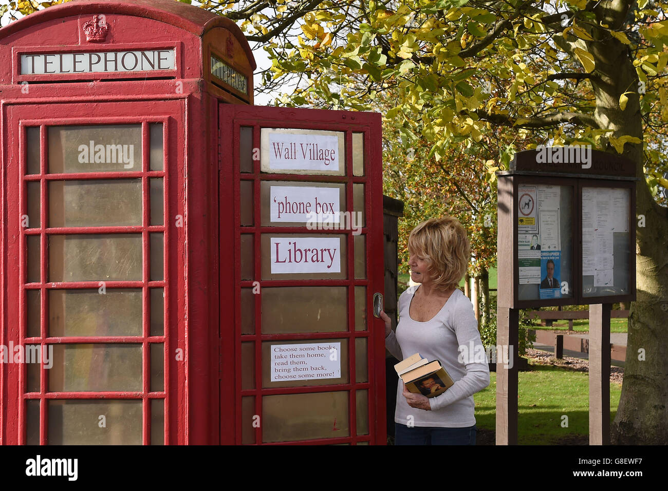Wall village telephone box library Stock Photo - Alamy
