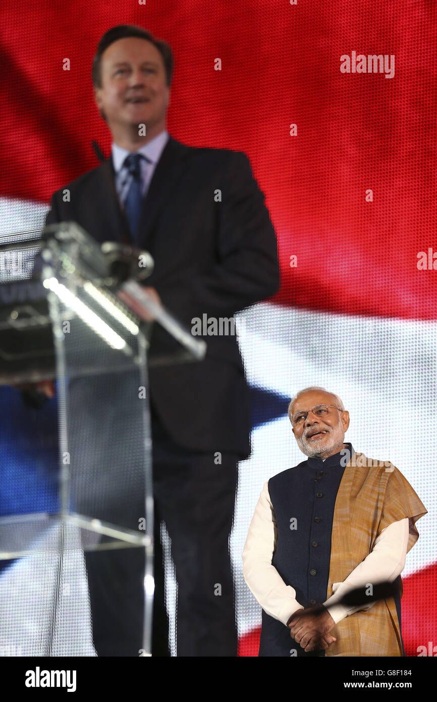 India's Prime Minister Narendra Modi (R) listens as British Prime ...