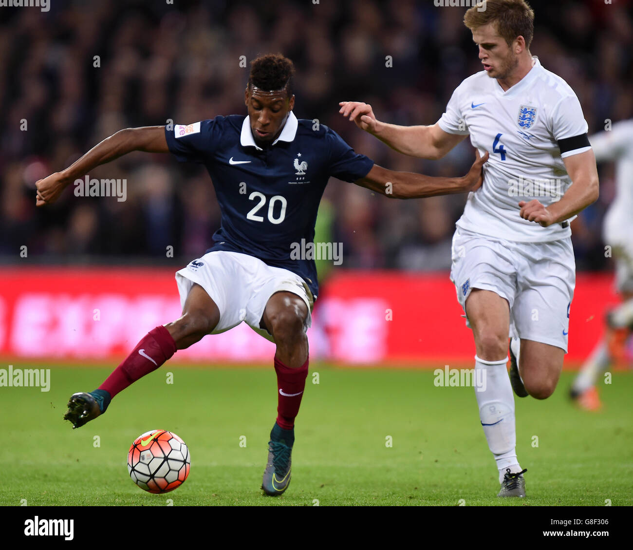 England's Eric Dier (right) and France's Kingsley Coman (left) battle ...