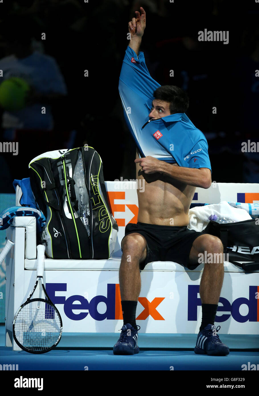 Novak Djokovic appears to struggle as he puts on a new shirt during day ...