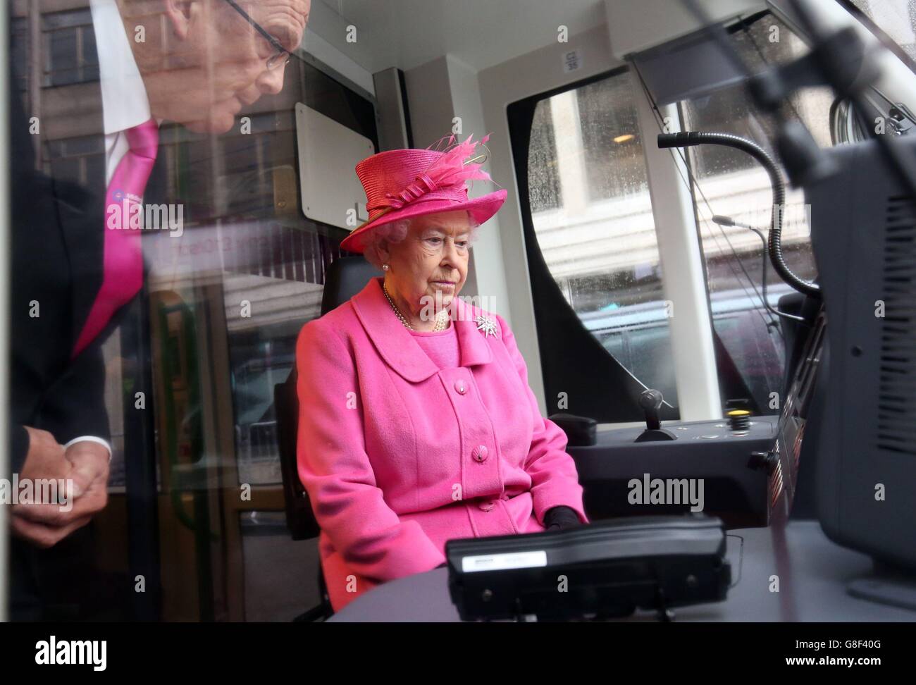 Queen Elizabeth II chats to senior driver Derek Taylor during a tour of ...
