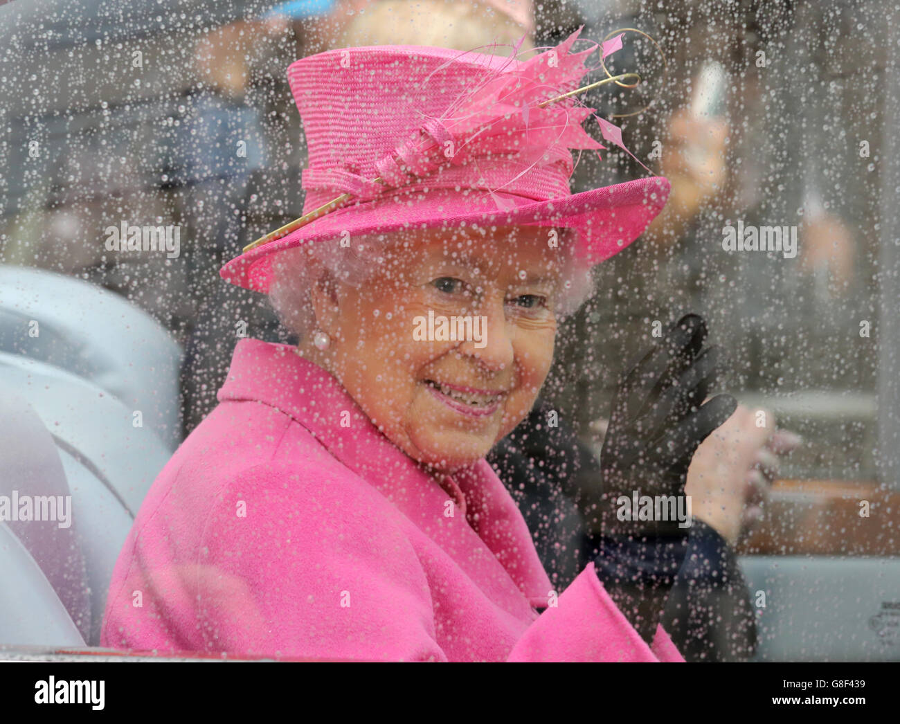 Queen Elizabeth II waves during a tour of a tram on the Metroline ...