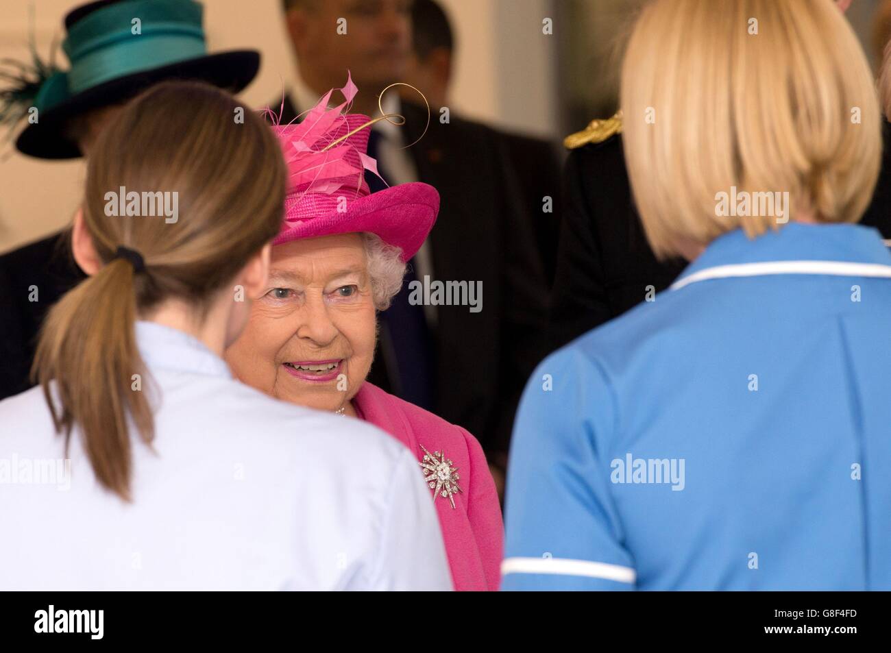 Queen Elizabeth II meets members of staff during a tour of the new ...
