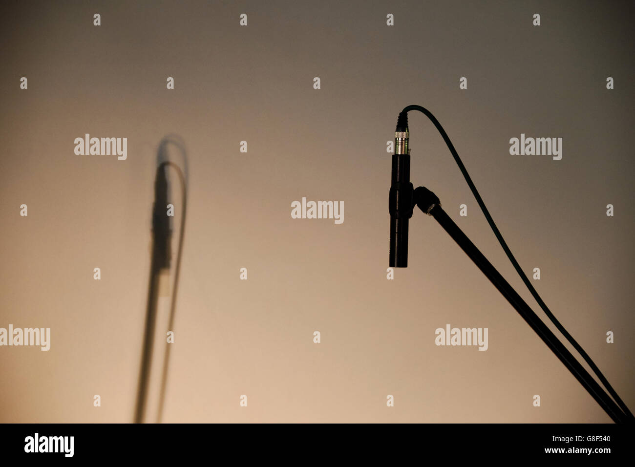 Studio recording microphone with stand and wire on the stage with ...