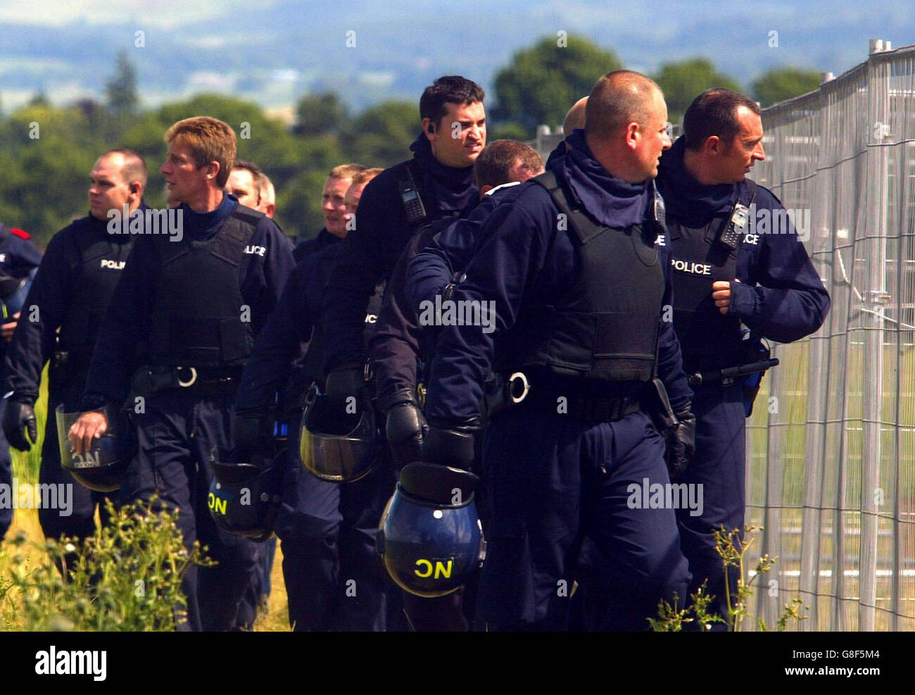 Police patrol the fence around the g8 summit in gleneagles hi-res stock ...