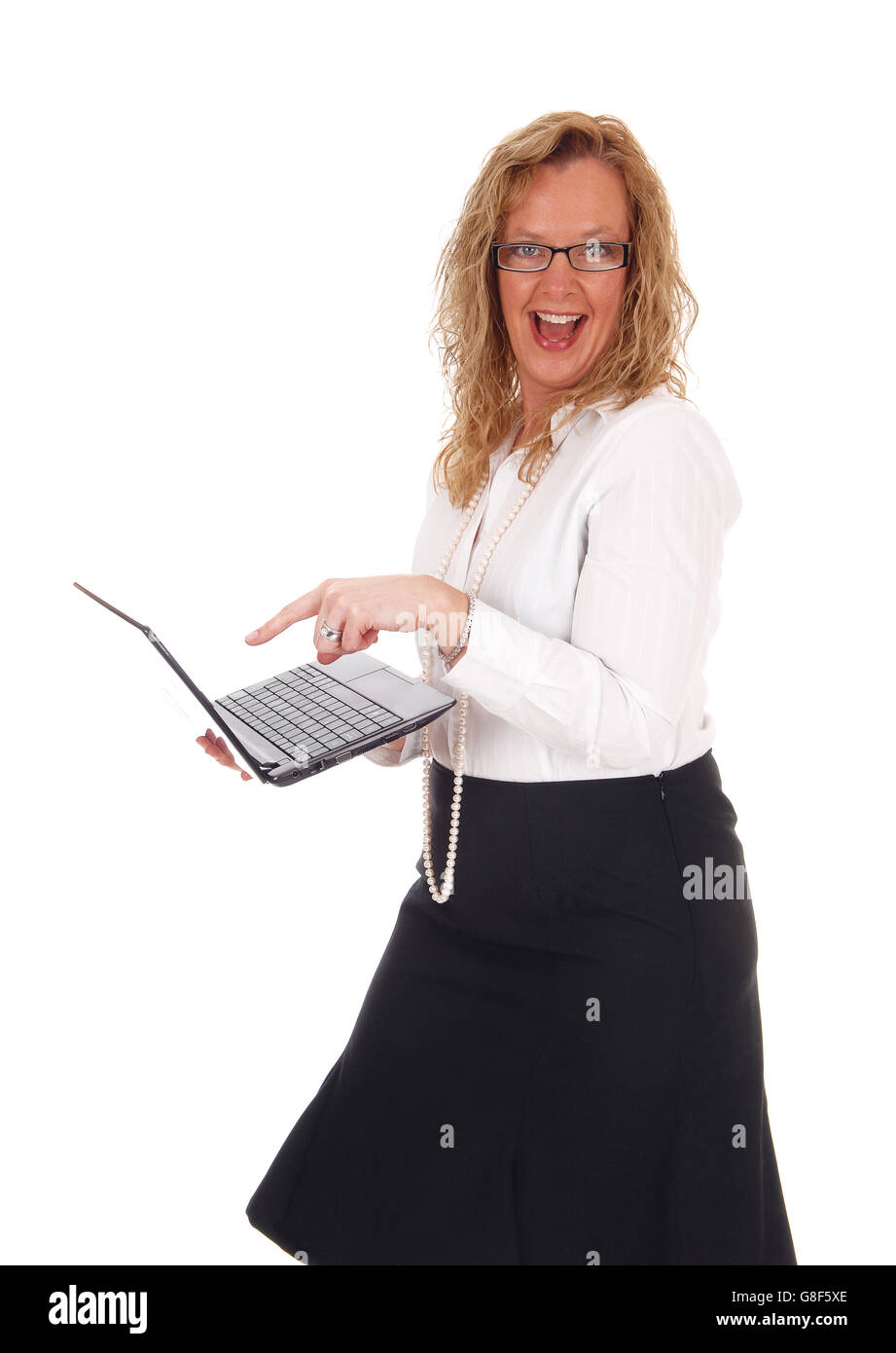 A trilled business woman standing in a black skirt white blouse holding ...