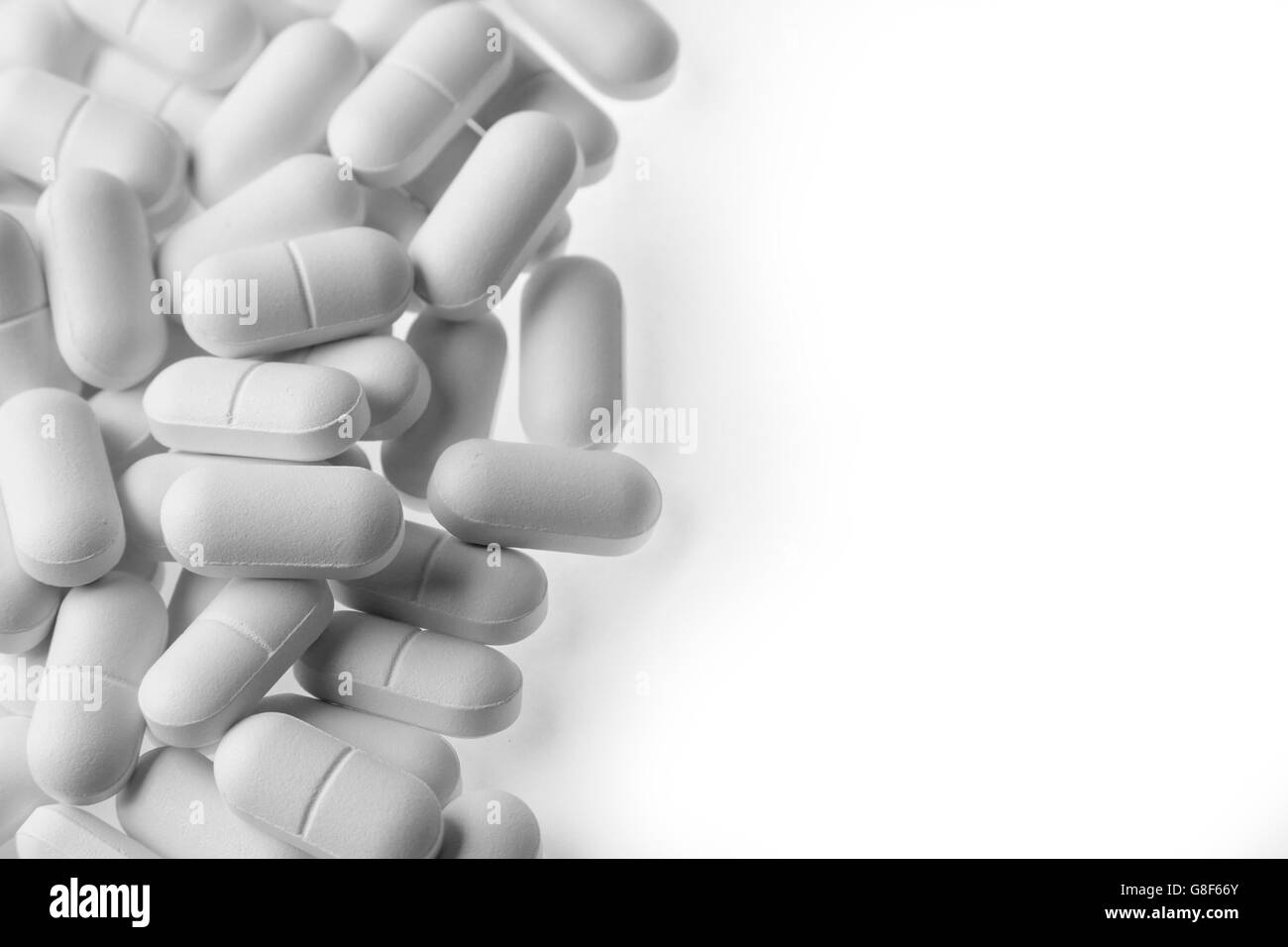 Pile of tablets closeup on plain background Stock Photo - Alamy