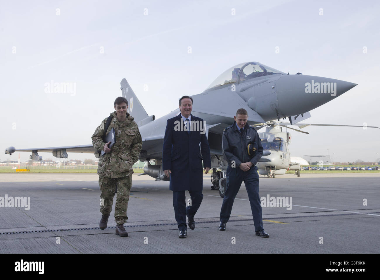 British Prime Minister David Cameron (centre) walks with Group Captain ...