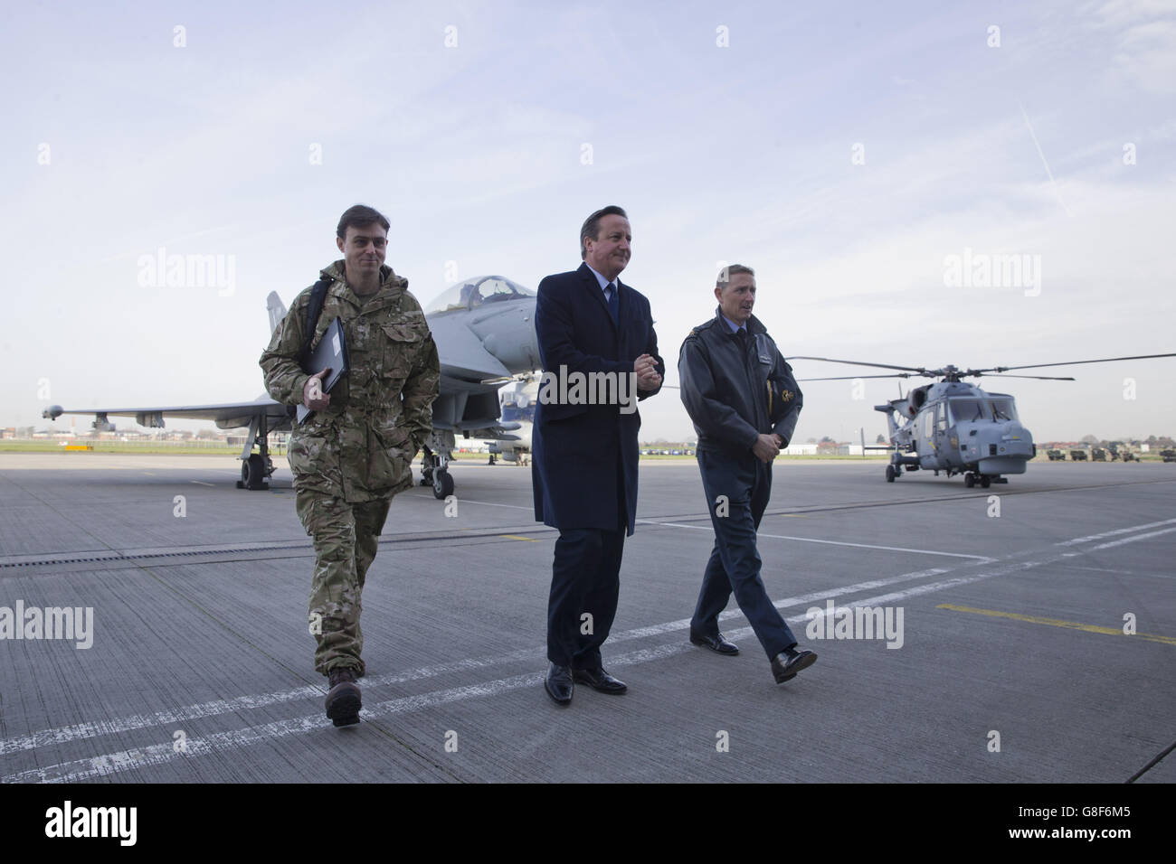 British Prime Minister David Cameron (centre) walks with Group Captain ...