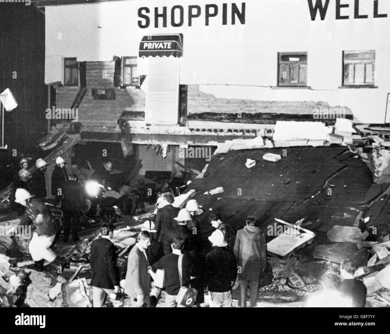 Rescue workers search the debris of the pub bombing in the village of ...