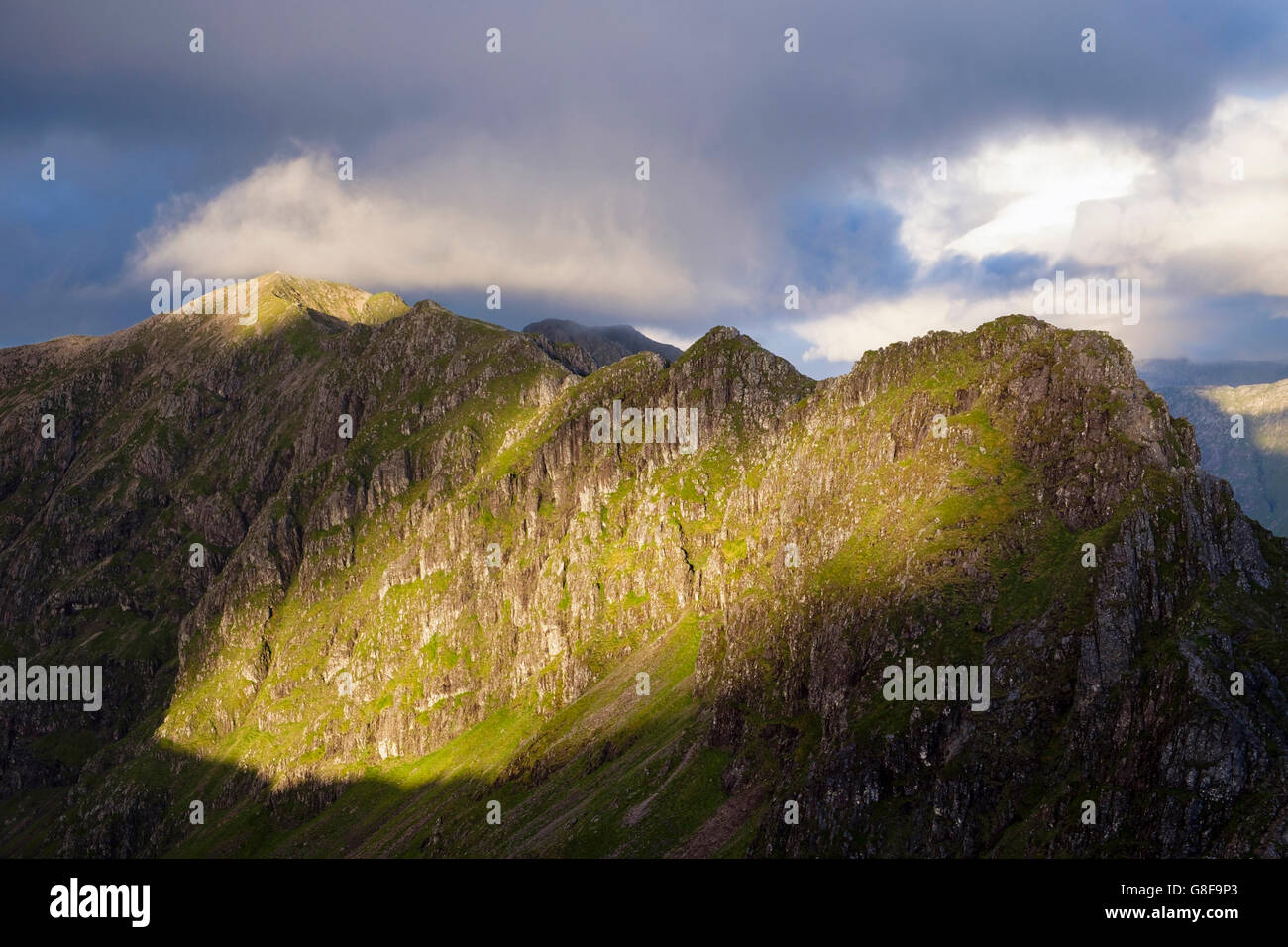 Aonach Eagach ridge and Meall Dearg mountain summit in evening sunlight ...