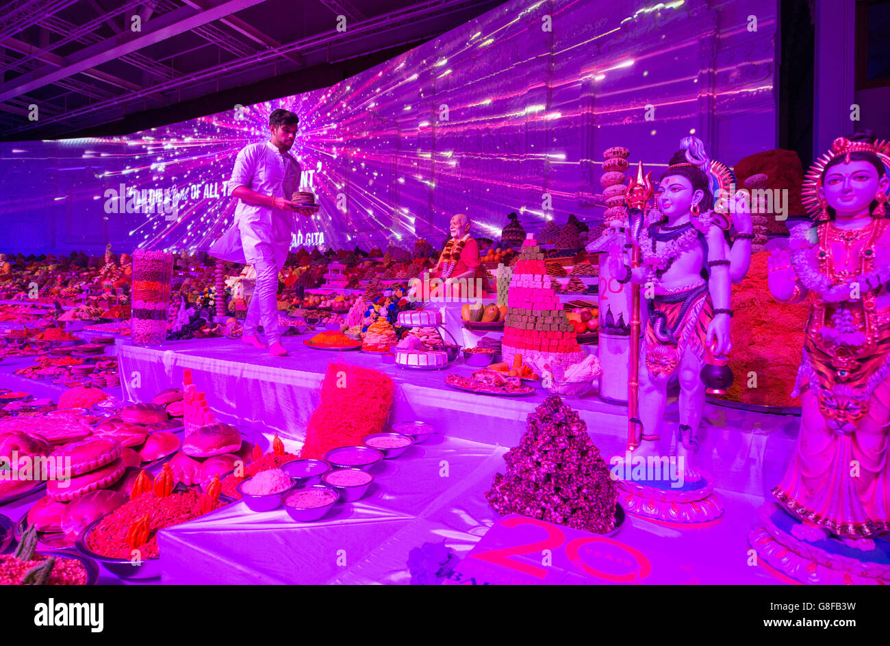 A volunteer arranges a variety of vegetarian food known as Annakut ...