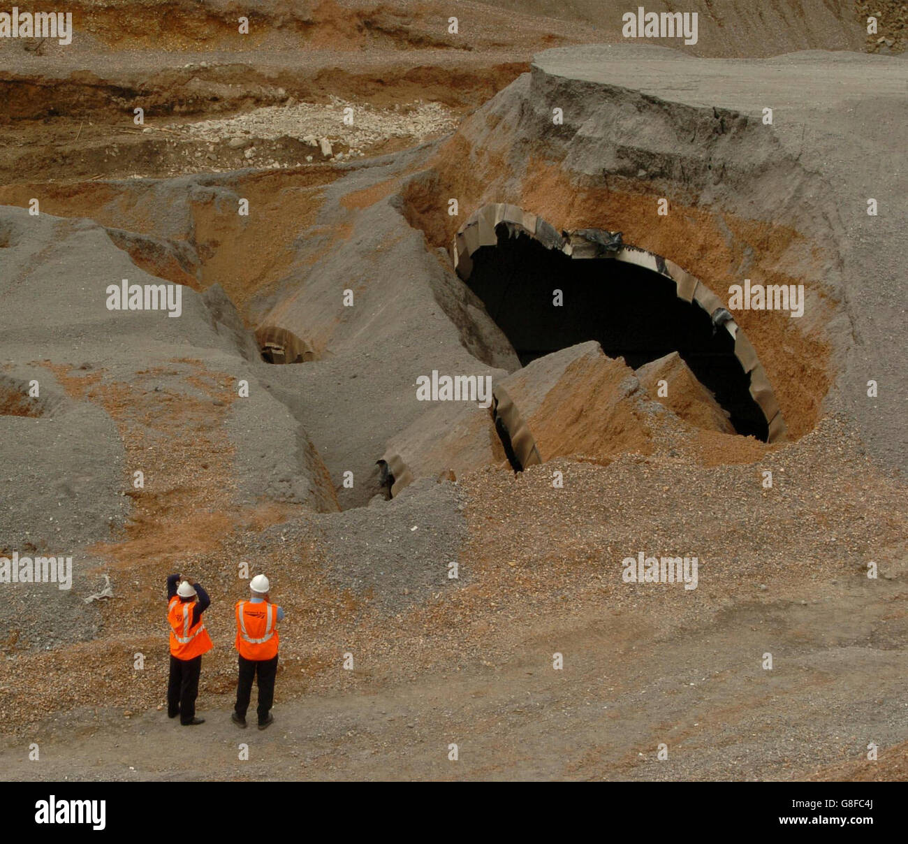 Workers from Network Rail survey the scene of last night's tunnel ...