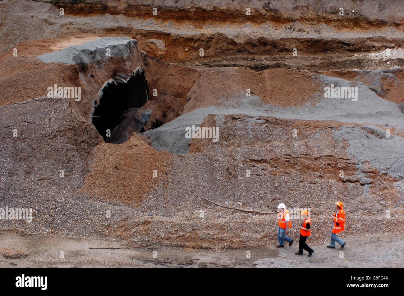Workers from Network Rail survey the scene of last night's tunnel ...