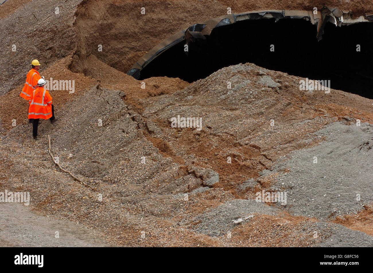 Workers from Network Rail survey the scene of last night's tunnel ...