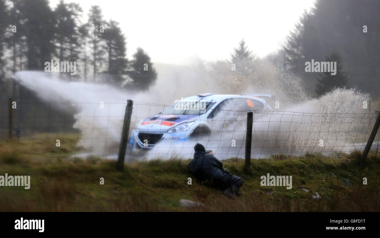 A spectator braves the water splash as car 45 driven by (IRE) Craig ...