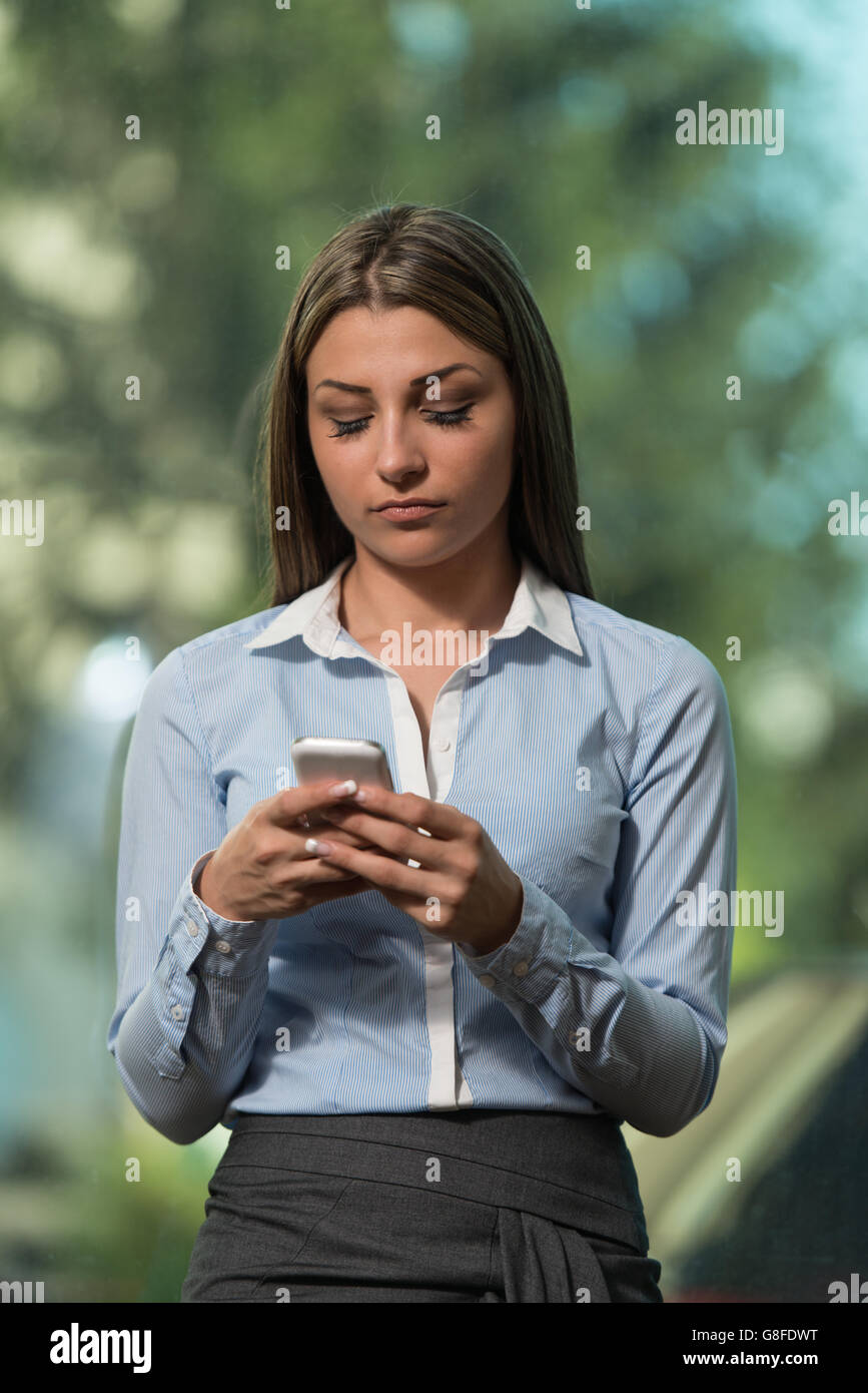 Portrait Of A Busy Sales Woman In Office And Using Her Cellphone ...
