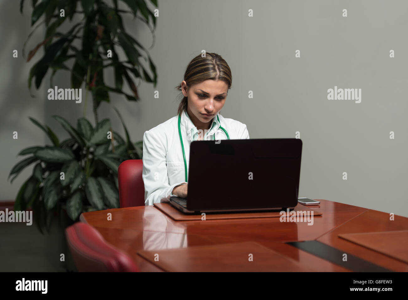 Young Pretty Female Doctor With Notebook In The Office - Successful ...