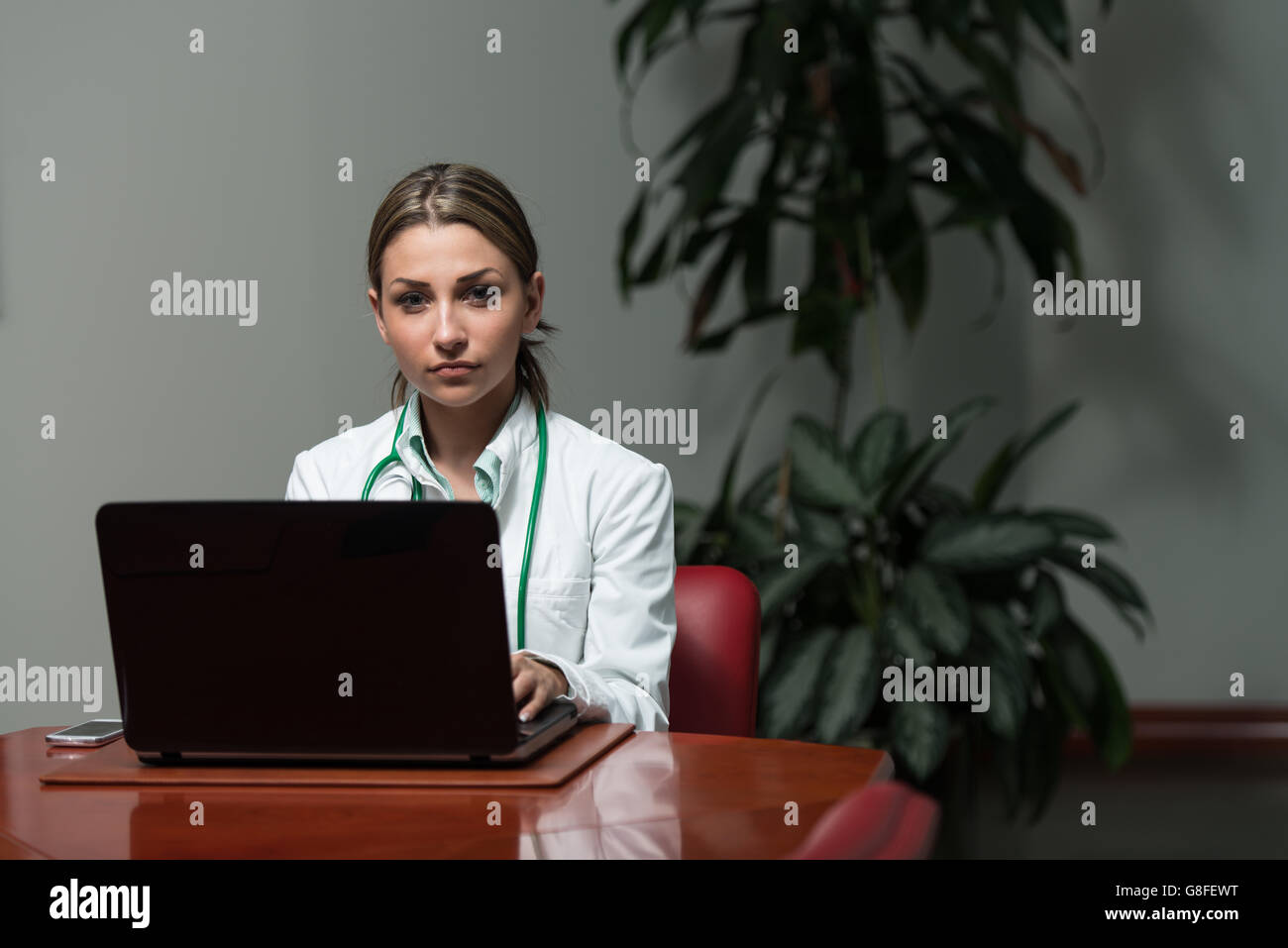 Young Pretty Female Doctor With Notebook In The Office - Successful ...