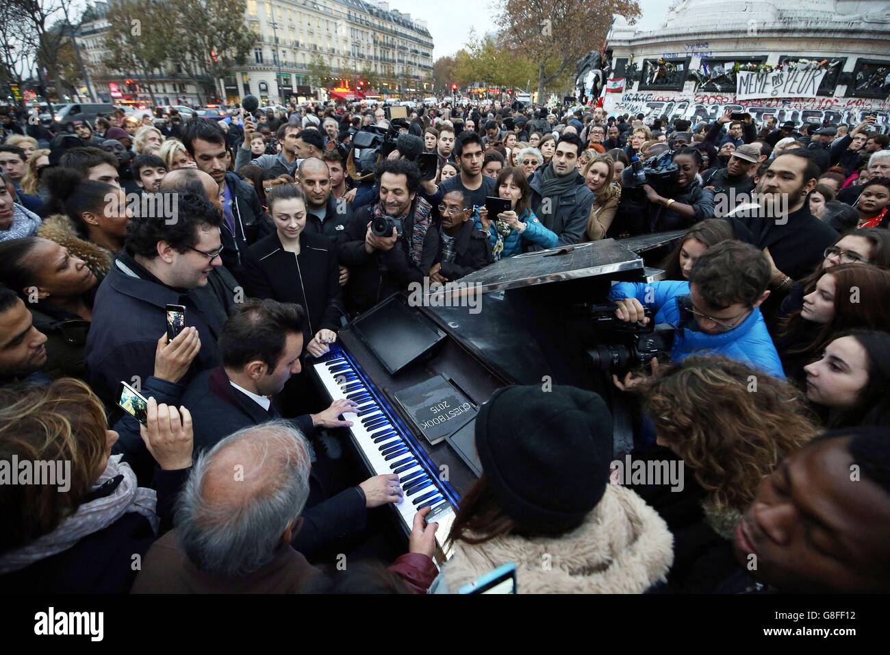 Crowds gather to listen to a piano being played at Place de la ...