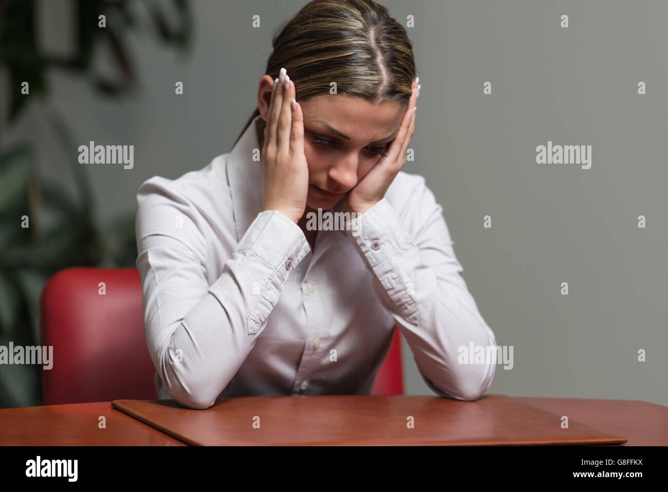 Stressed Woman Holding Her Head With Hand In Office - Business Woman ...