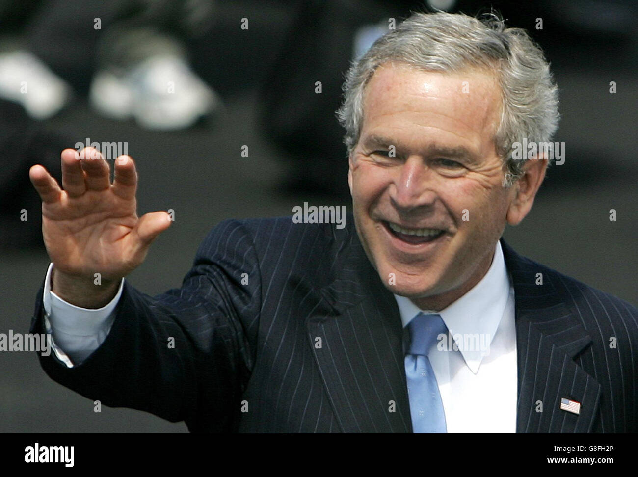 President George Bush waves at onlookers as he arrives, at Prestwick ...