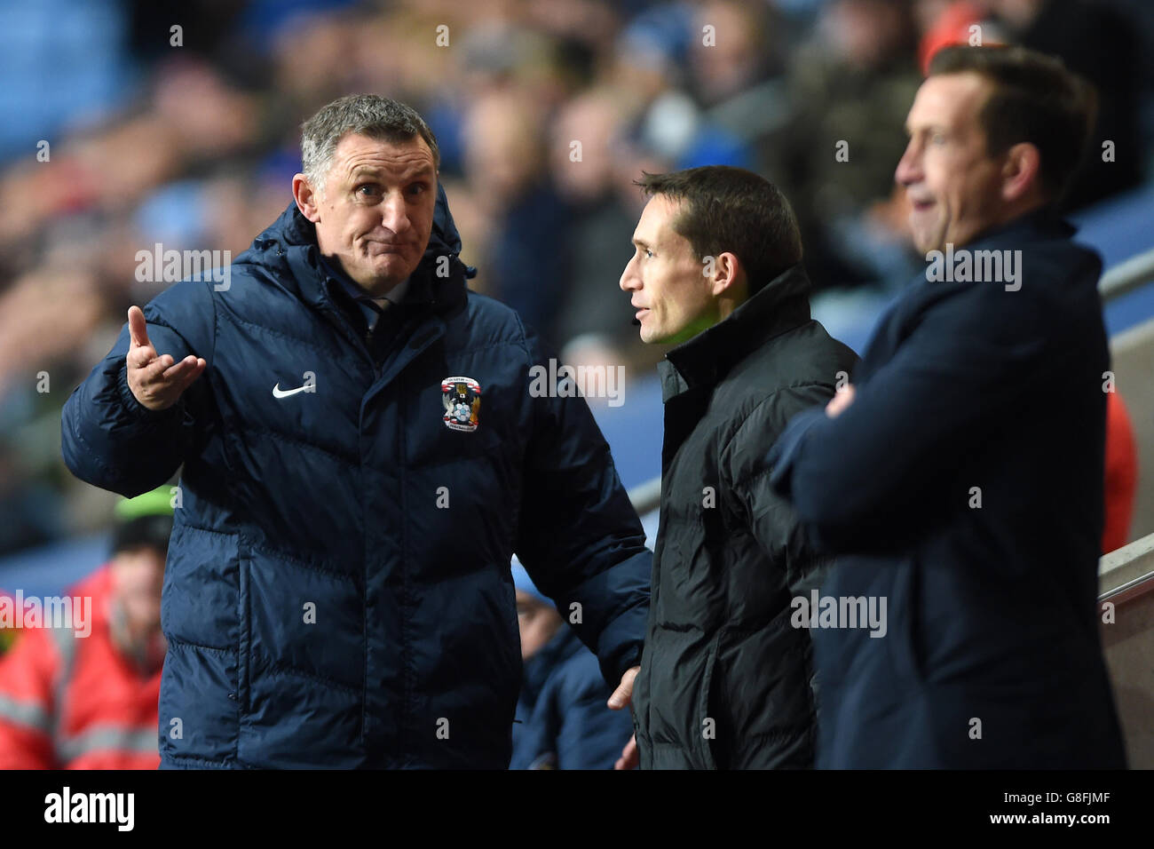 Coventry City manager Tony Mowbray (left) talks to the fourth offical ...