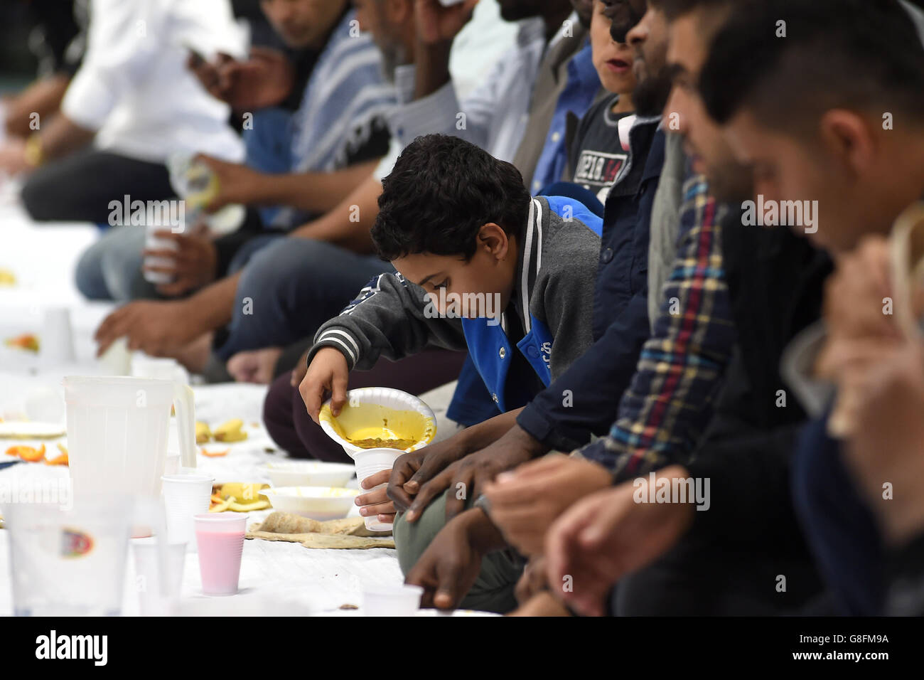 Muslim men break their fast after sunset during the holy month of ...