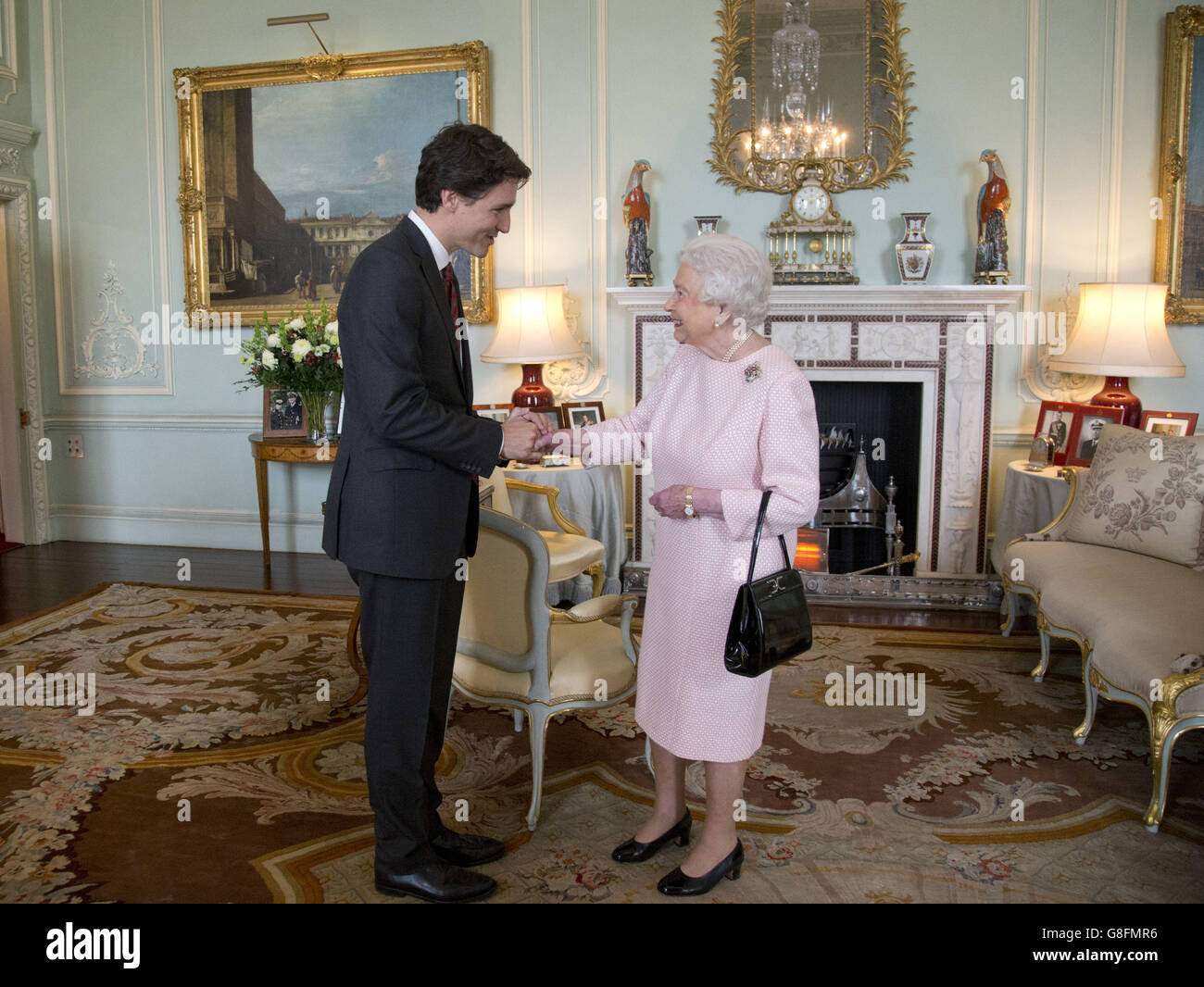 Prime Minister of Canada Justin Trudeau shakes hands with Queen ...
