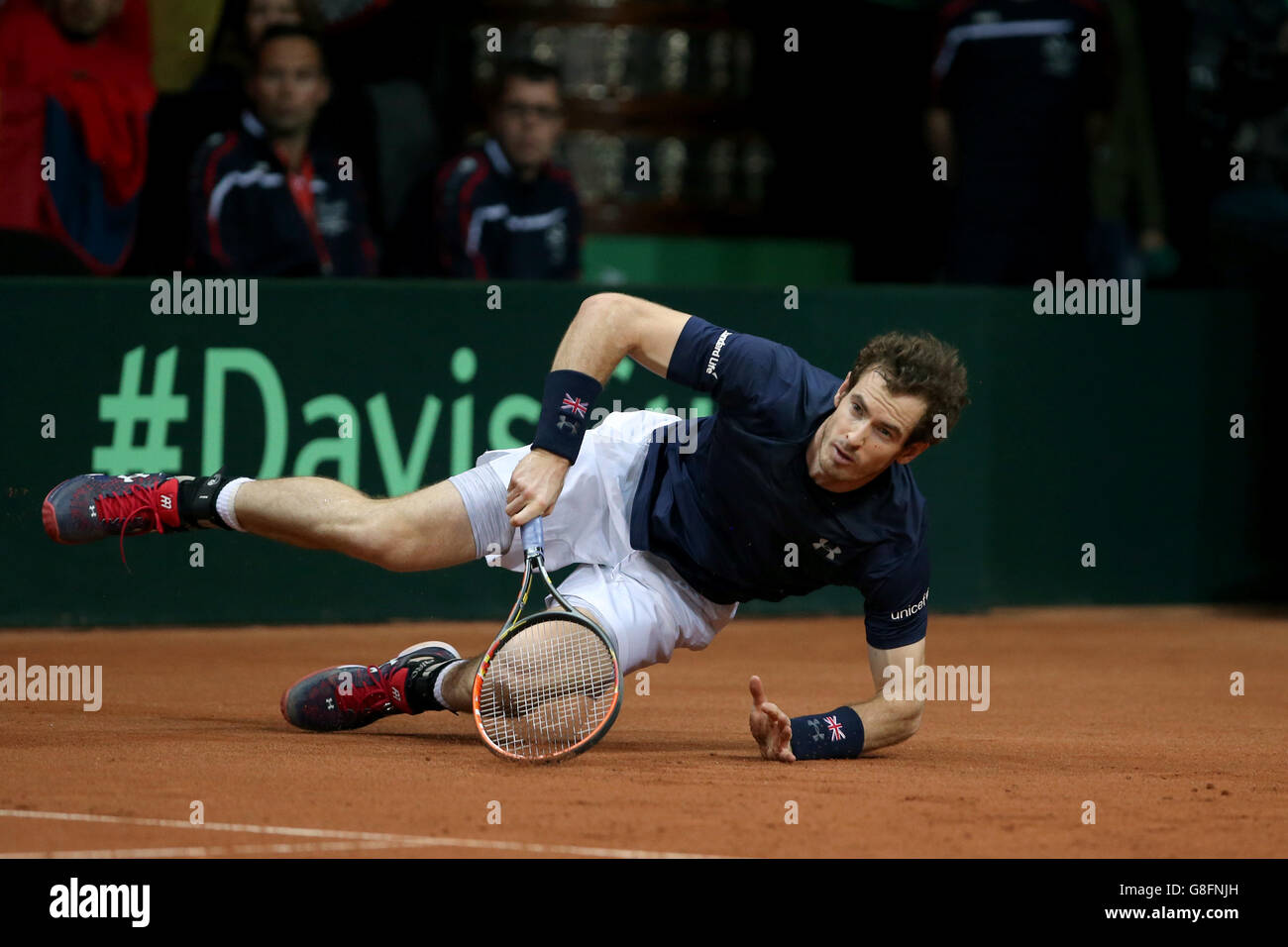 Great Britain's Andy Murray falls during his match against Belgium's ...
