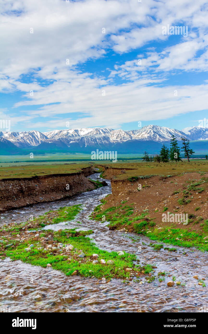 Small river with rocky shores flowing through a mountain valley Stock ...