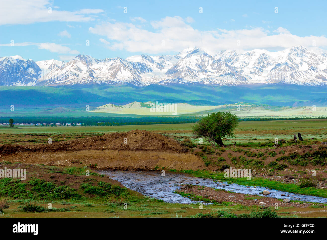 Small river with rocky shores flowing through a mountain valley Stock ...