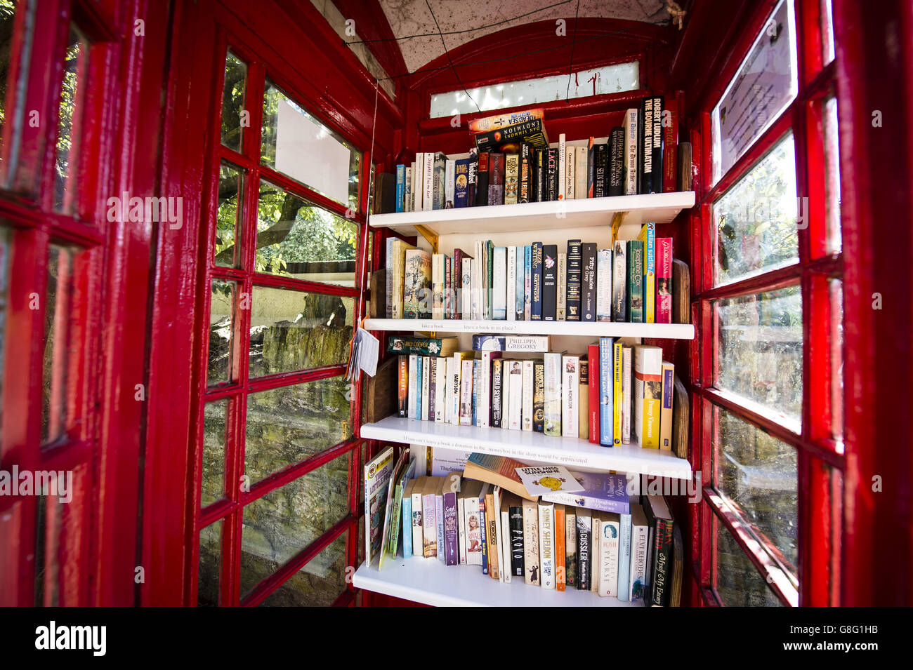 An old red telephone box converted into a book exchange in the village ...