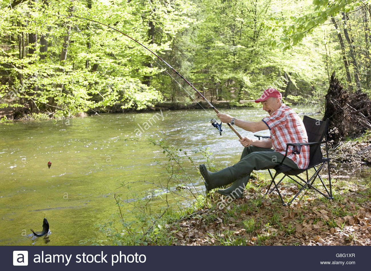Man Sitting In Chair Fishing Stock Photos & Man Sitting In Chair ...