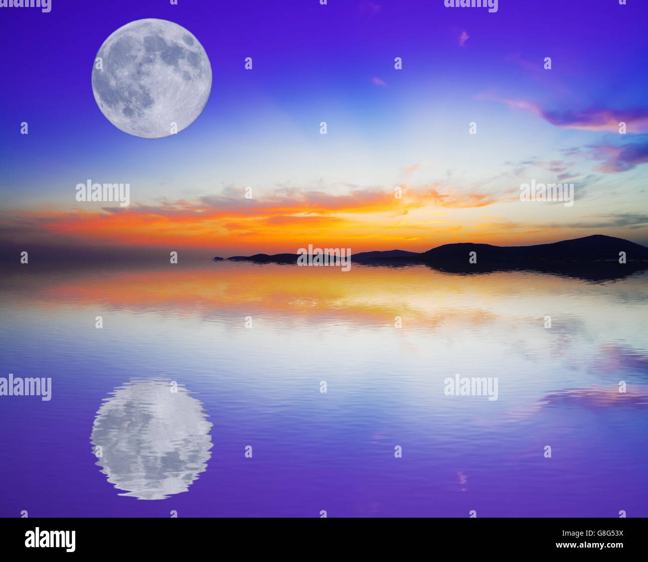 huge moon in a blue and orange sky reflected in the water Stock Photo ...