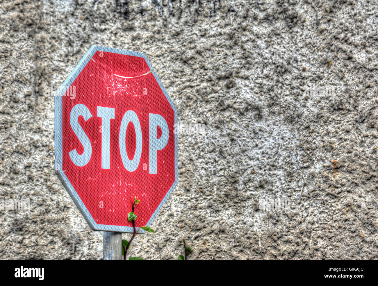 stop sign with a rustic wall in the background Stock Photo - Alamy
