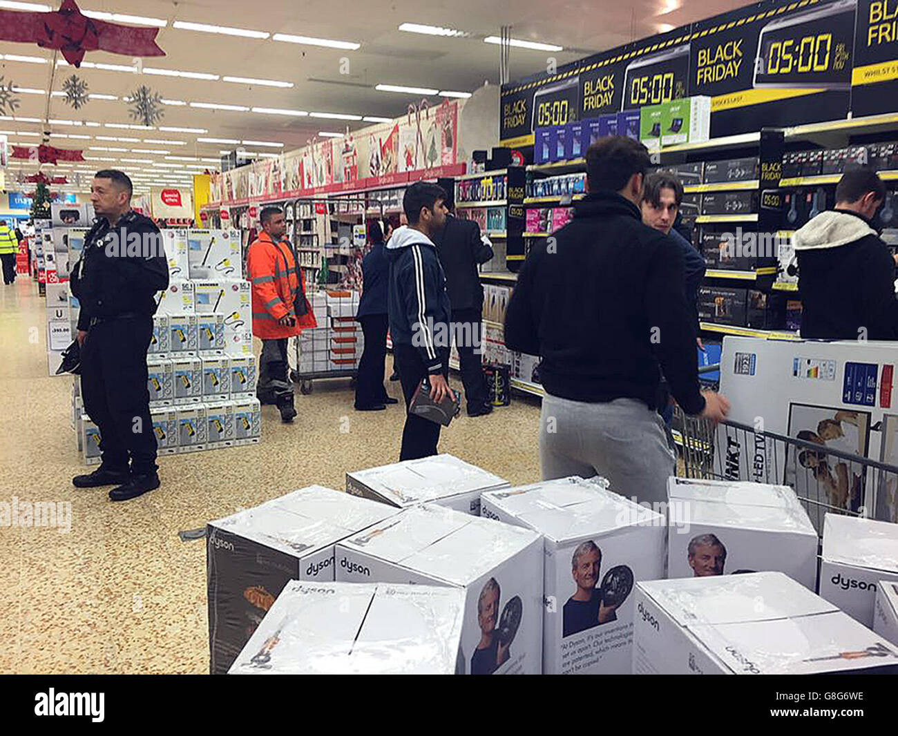 Shoppers buy items discounted in the Black Friday sales at Tesco Extra ...