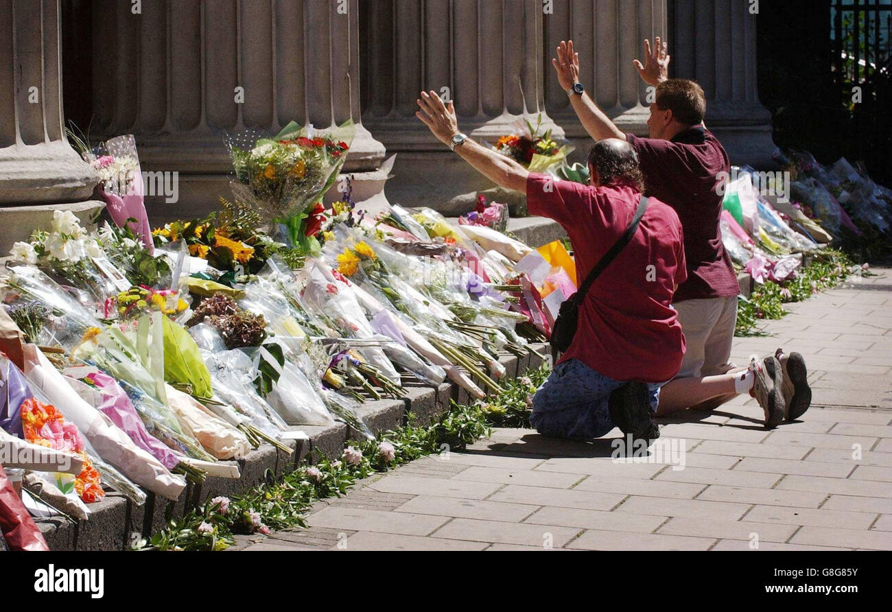 Two tourists show their respect at the scene of the bomb explosion on a ...